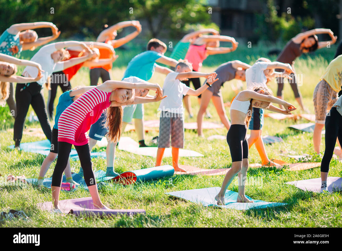 Yoga classes outside on the open air. Kids Yoga Stock Photo - Alamy