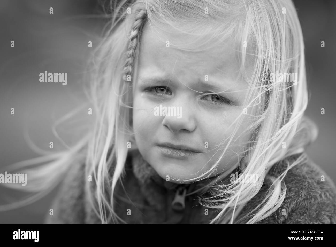 A pretty little blonde girl crying after being bullied at School ...
