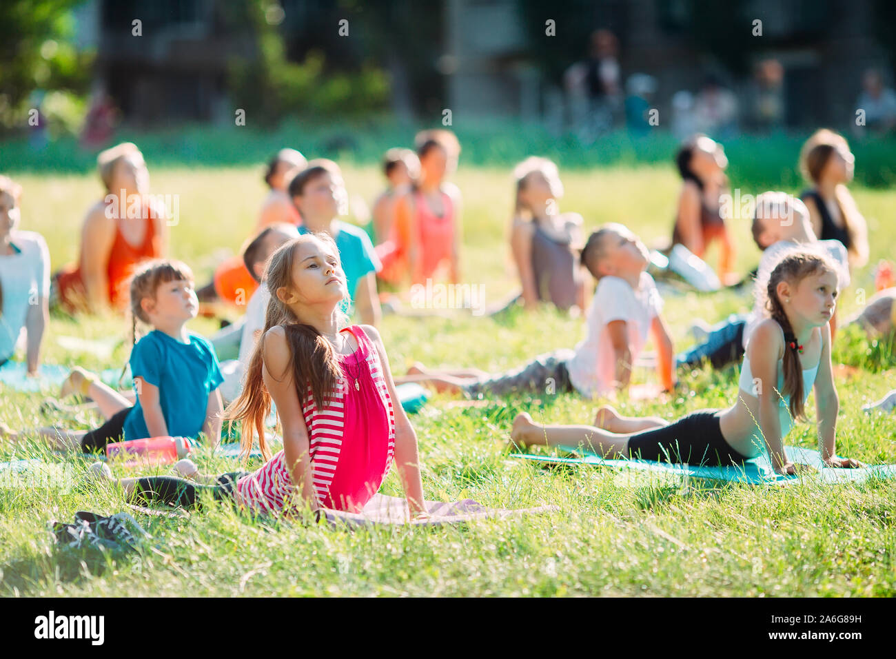Yoga classes outside on the open air. Kids Yoga Stock Photo - Alamy