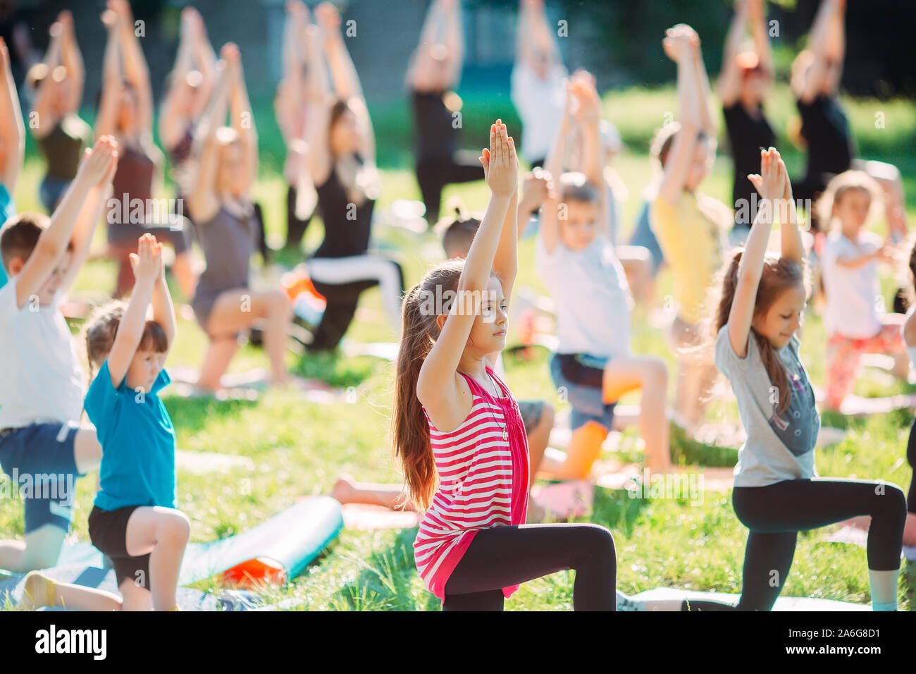 Yoga classes outside on the open air. Kids Yoga Stock Photo - Alamy