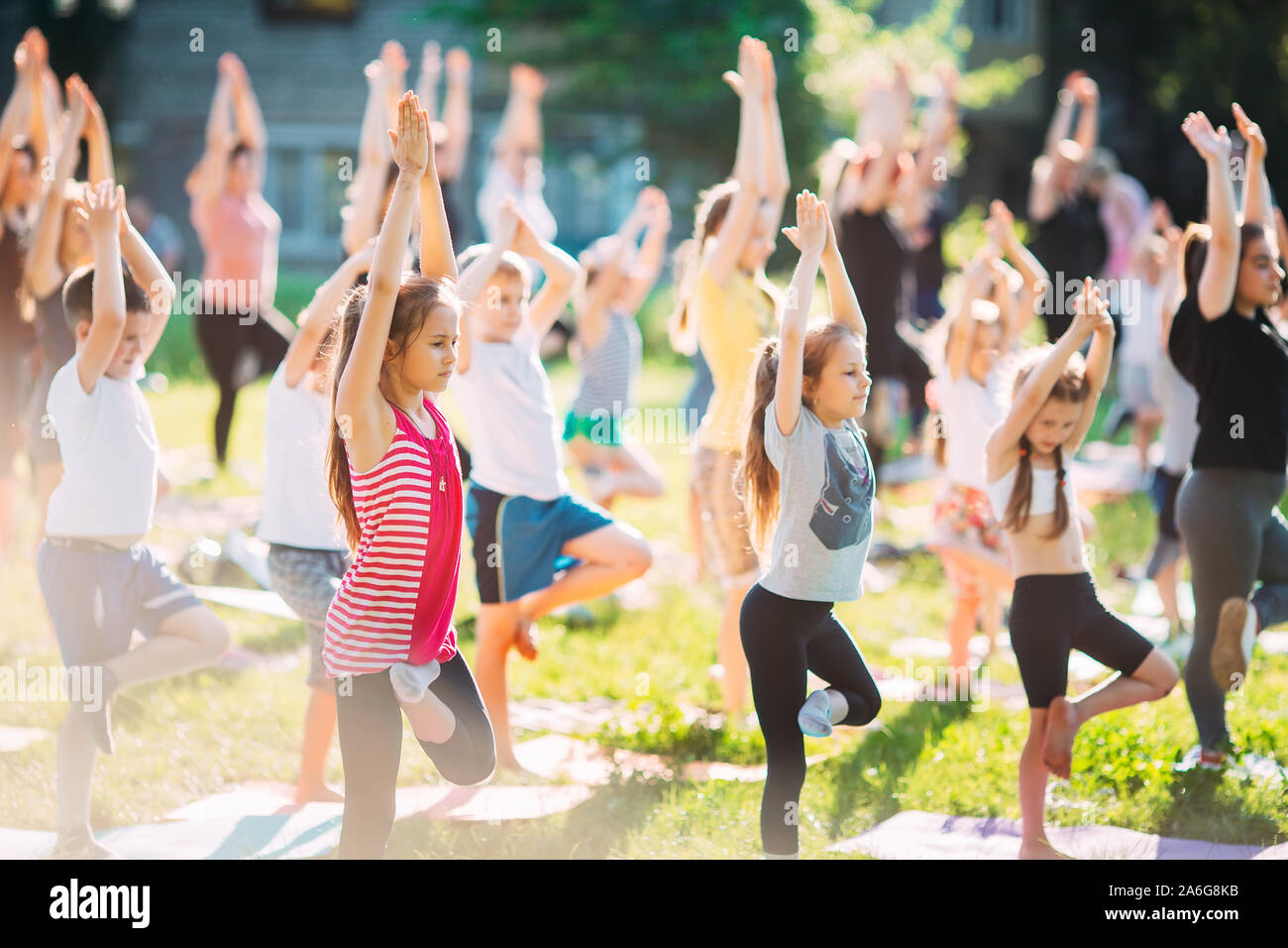Yoga classes outside on the open air. Kids Yoga Stock Photo - Alamy