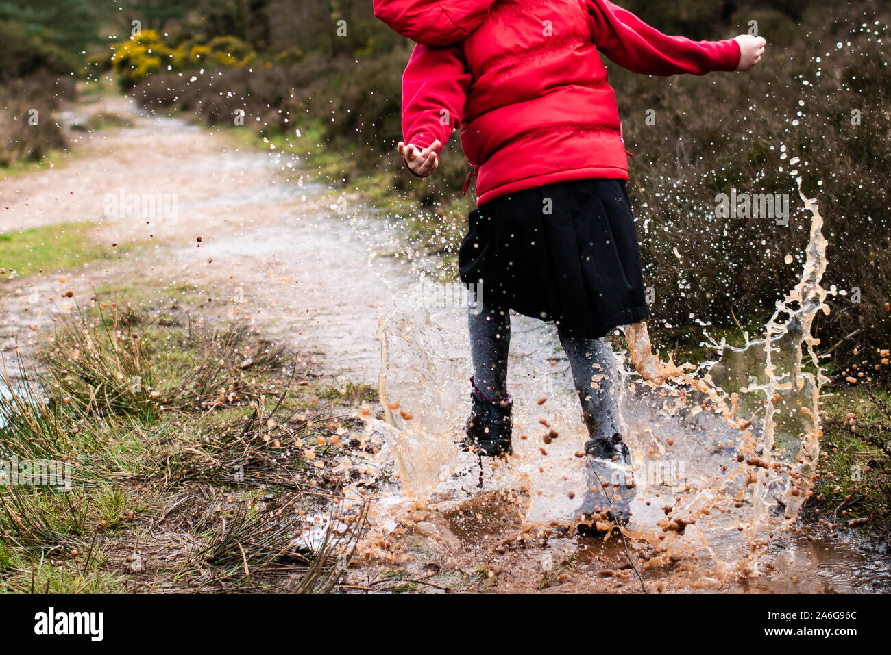 Girl Jumping In Muddy Puddle Stock Photos & Girl Jumping In Muddy Puddle Stock Images - Alamy