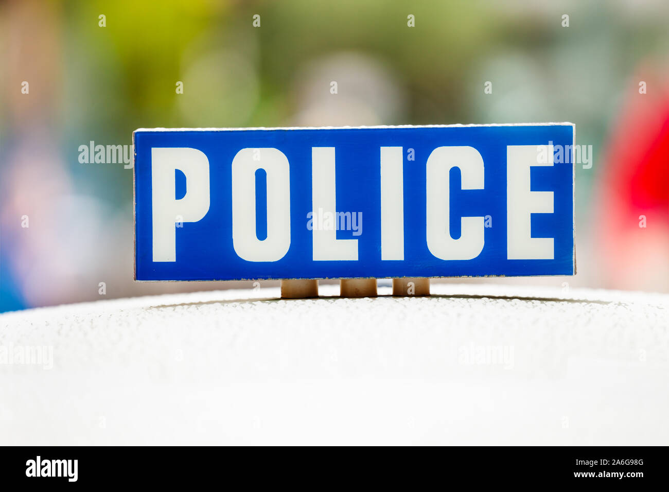 Police sign on car roof of over city background Stock Photo - Alamy