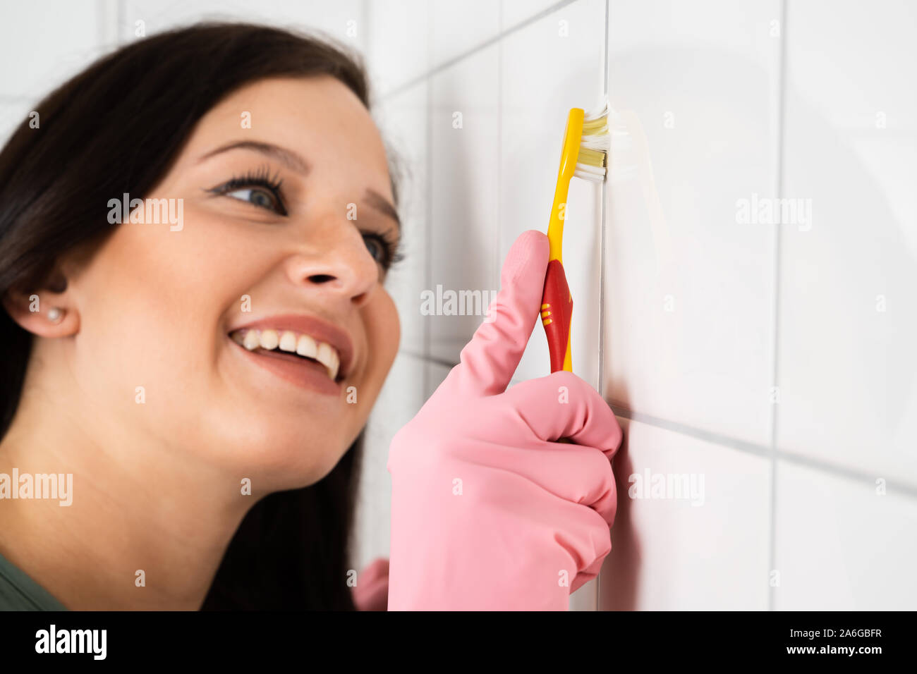 Close-up Of Person Hand Cleaning The Dirty White Tile Of The Wall Using ...
