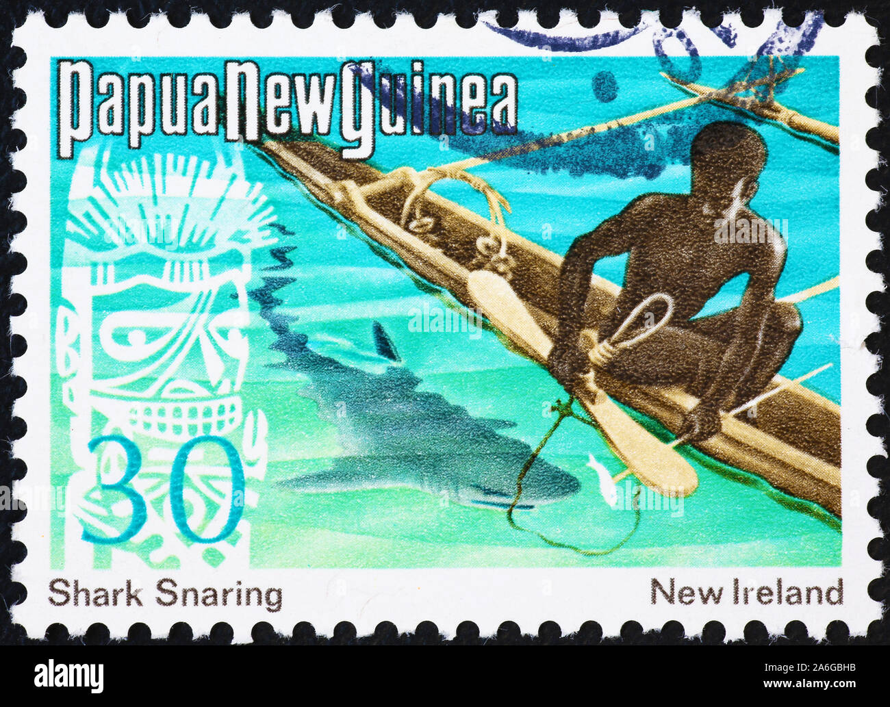 Fisherman snaring a shark on papuan postage stamp Stock Photo - Alamy