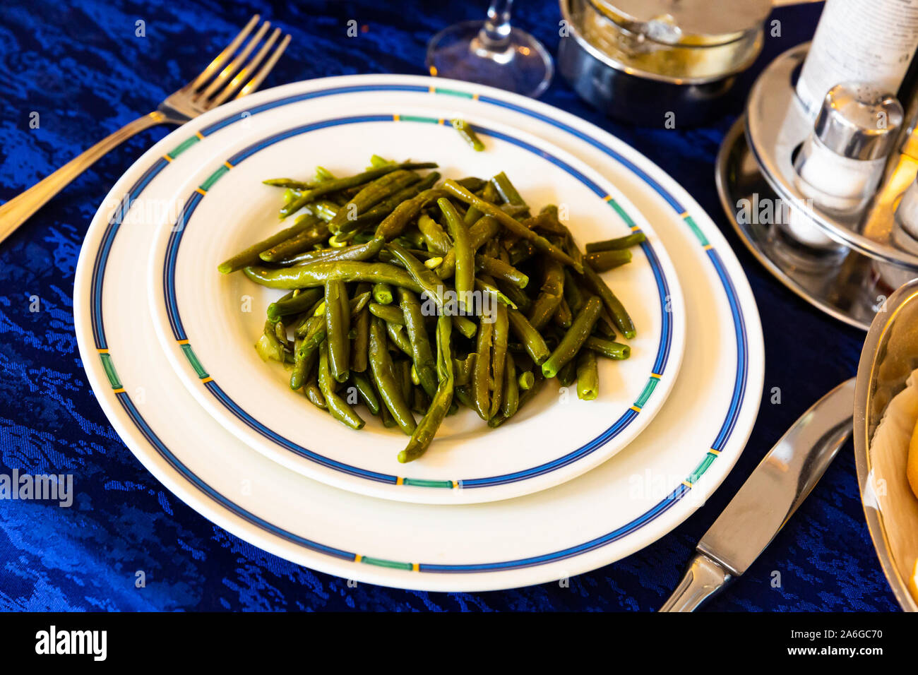 Delicious vegetable garnish of stewed green beans on white plate Stock ...