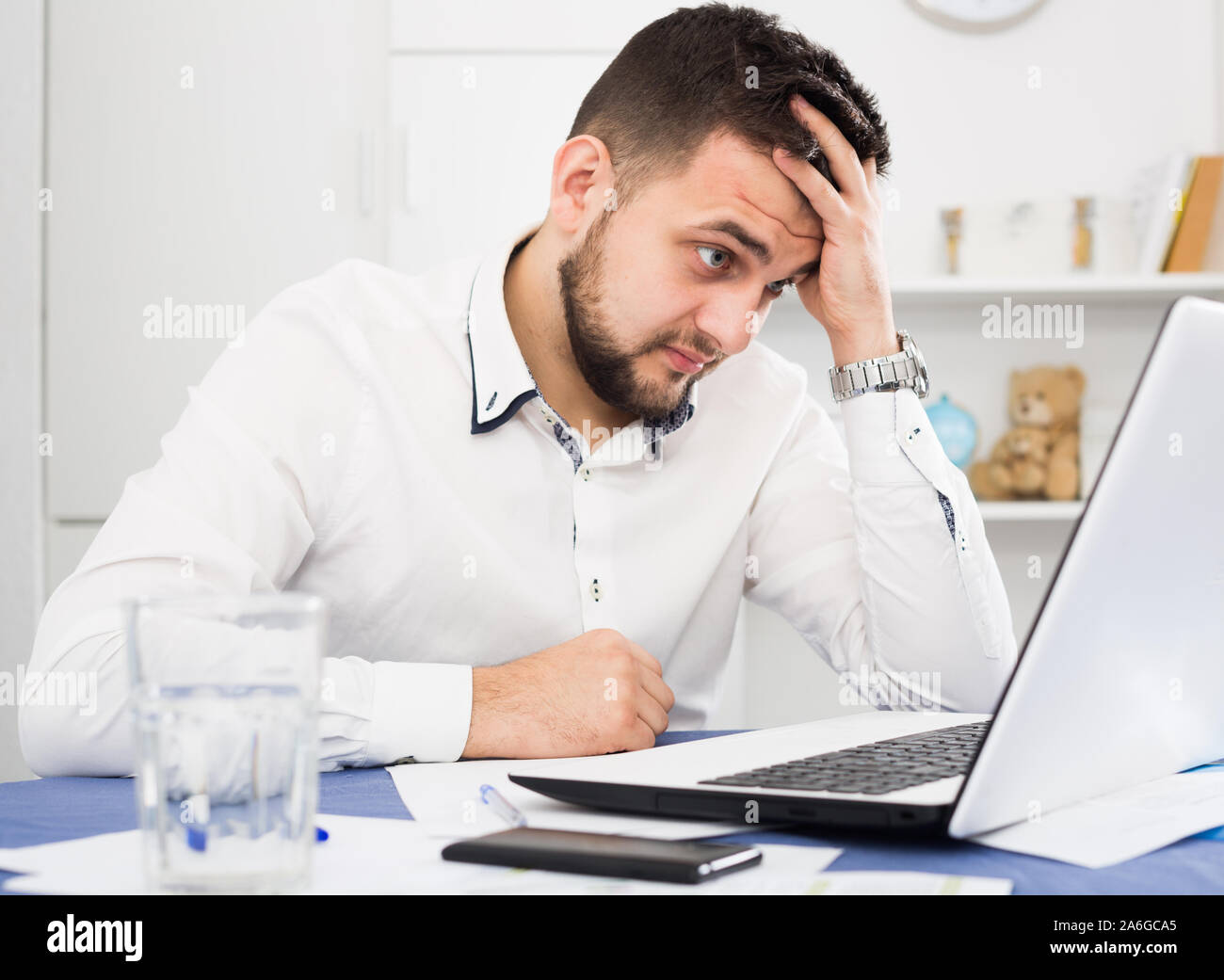 Stressed man worker facing challenge in project in office Stock Photo ...