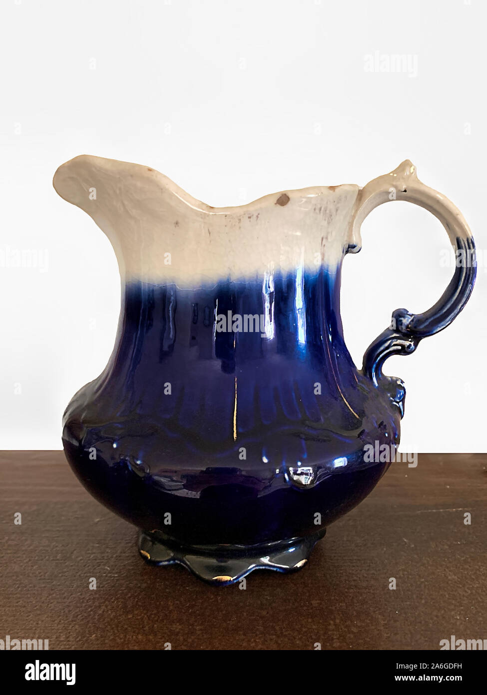 Very old antique flow blue pitcher with deep blue bleeding into top ...