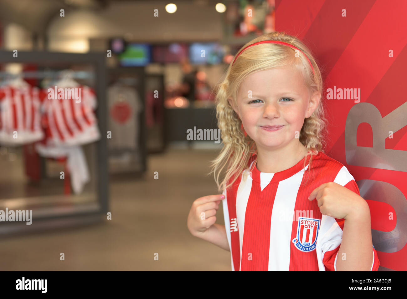 A beautiful little girl stands in the Stoke City shop in her new Stoke ...