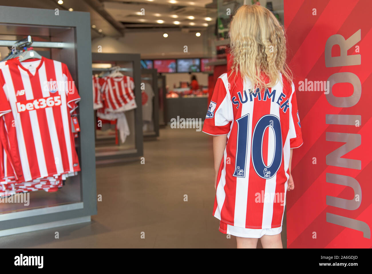A beautiful little girl stands in the Stoke City shop in her new Stoke ...