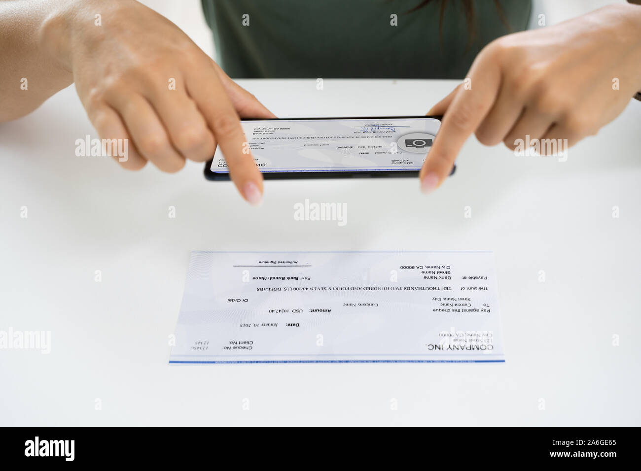 Woman Taking Photo Of Cheque To Make Remote Deposit In Bank Stock Photo ...
