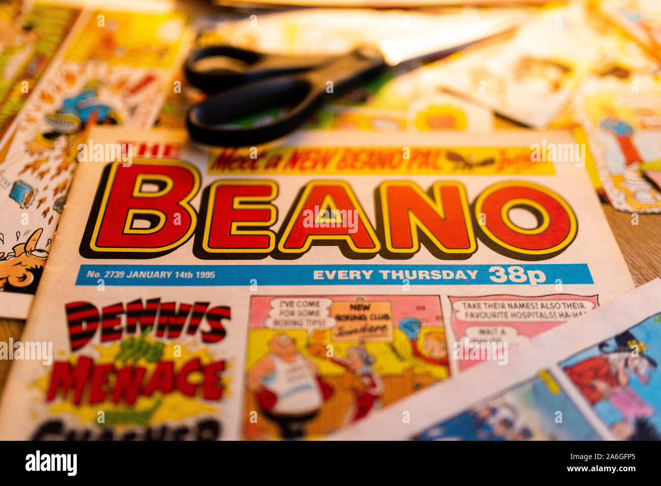 The world famous Beano comic book laid out on a desk with some scissors ...