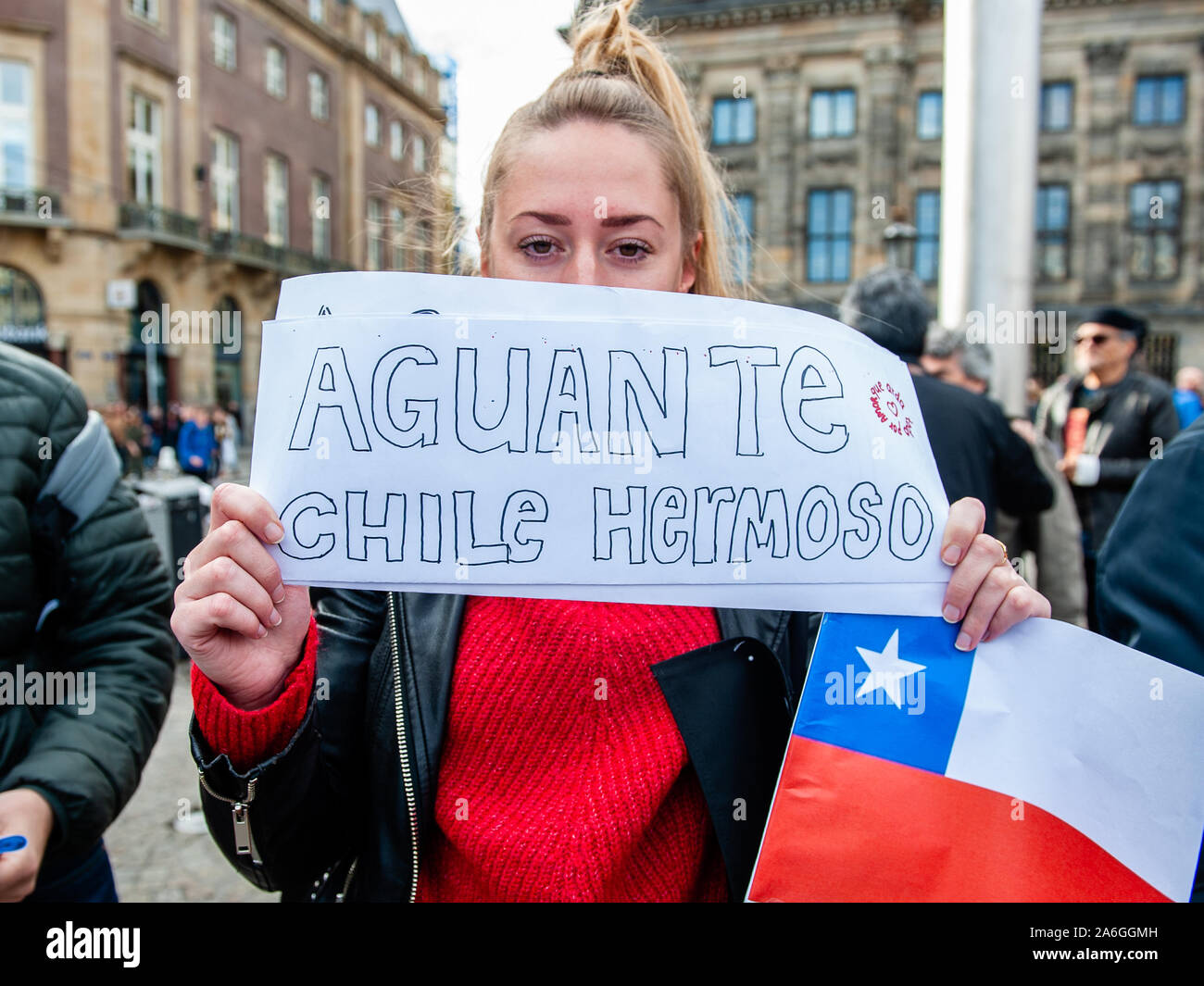 A woman holding a placard in front of her face during the demonstration ...