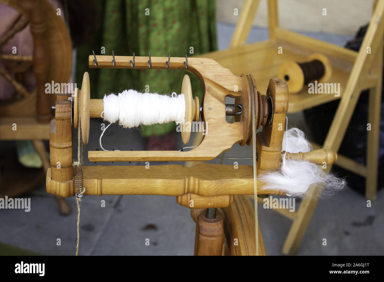 Spinning wool on sewing wheel, manufacturing and work, crafts Stock ...