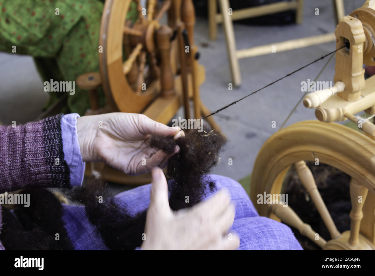 Spinning wool on sewing wheel, manufacturing and work, crafts Stock ...
