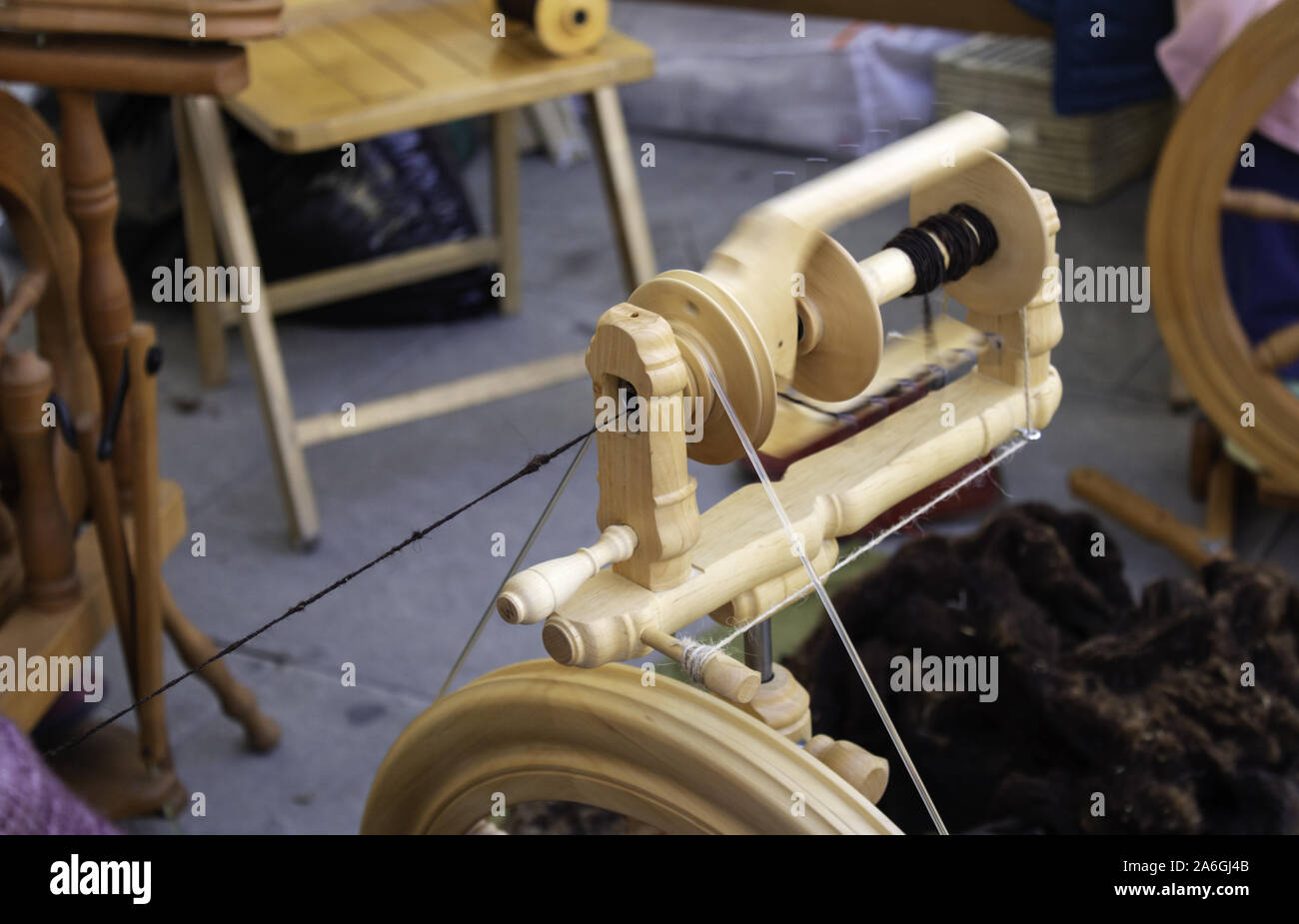 Spinning wool on sewing wheel, manufacturing and work, crafts Stock ...
