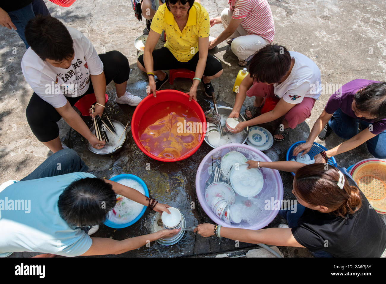 Women wash up their crockery, chopsticks and cutlery inside the Ancient ...