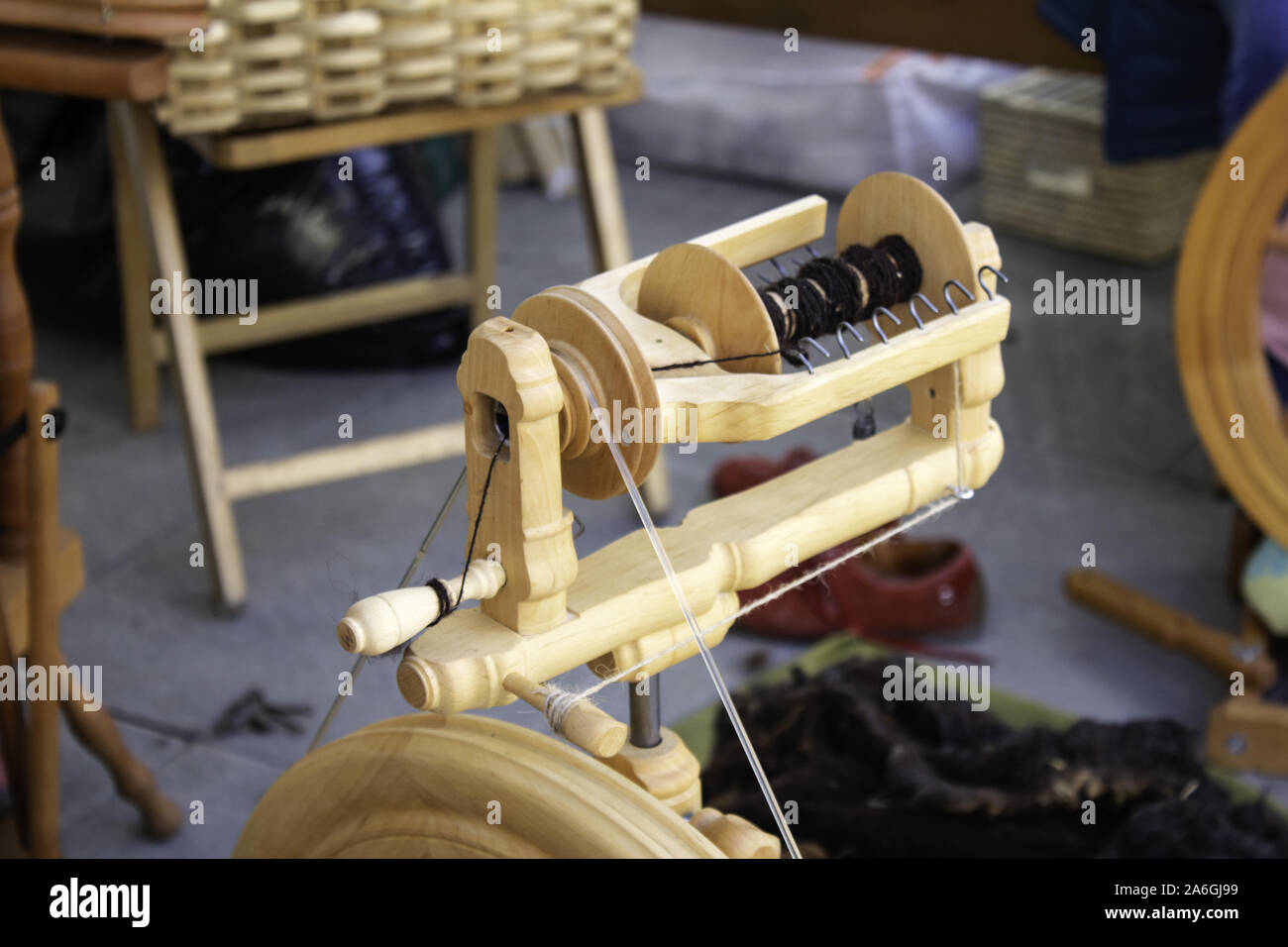 Spinning wool on sewing wheel, manufacturing and work, crafts Stock ...