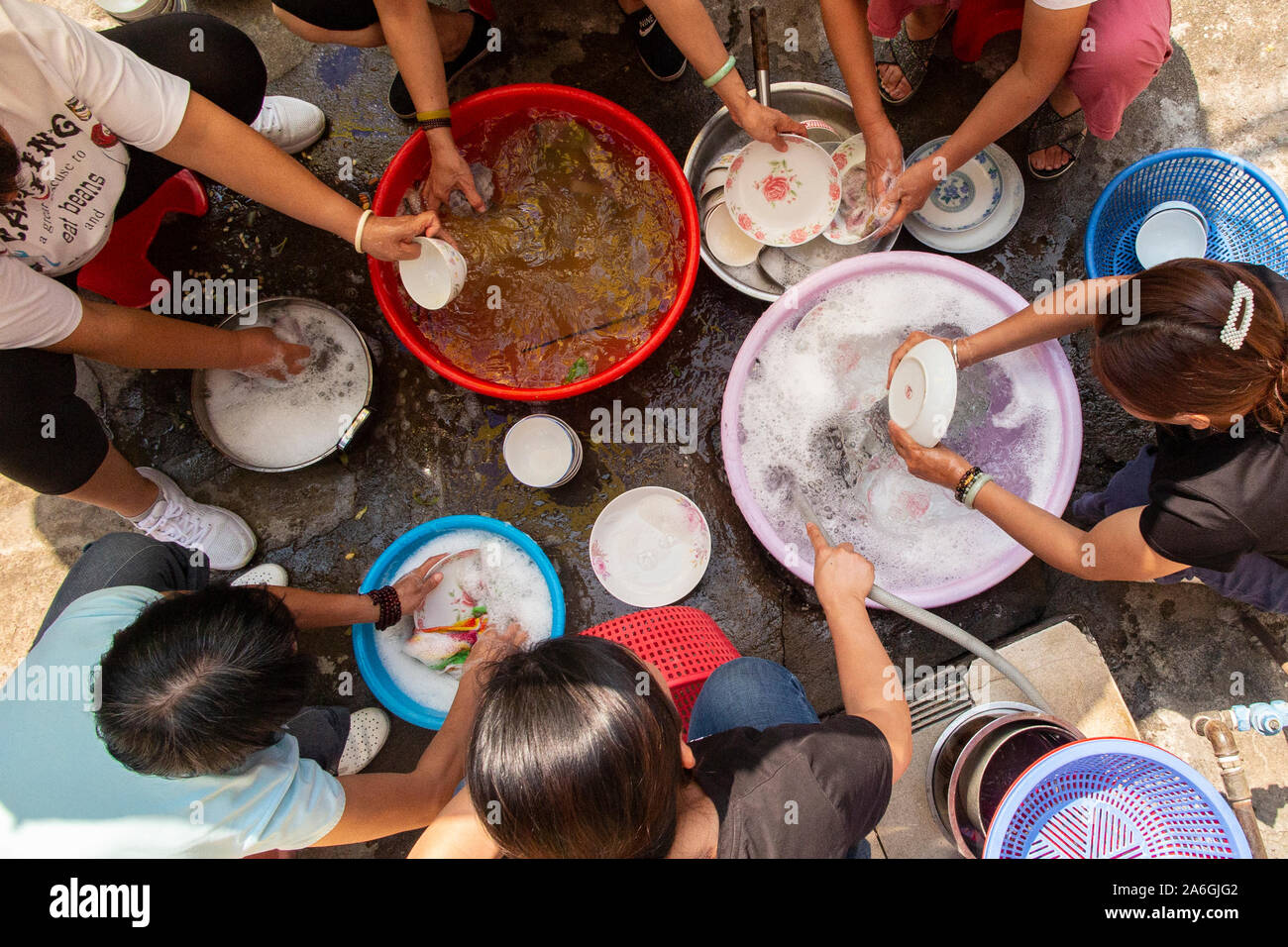 Women wash up their crockery, chopsticks and cutlery inside the Ancient ...
