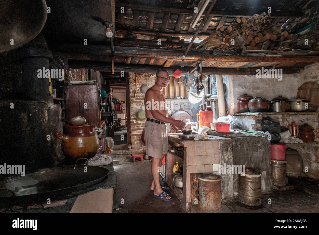 A Chinese gentleman cooks in his kitchen in a house Inside the Ancient ...
