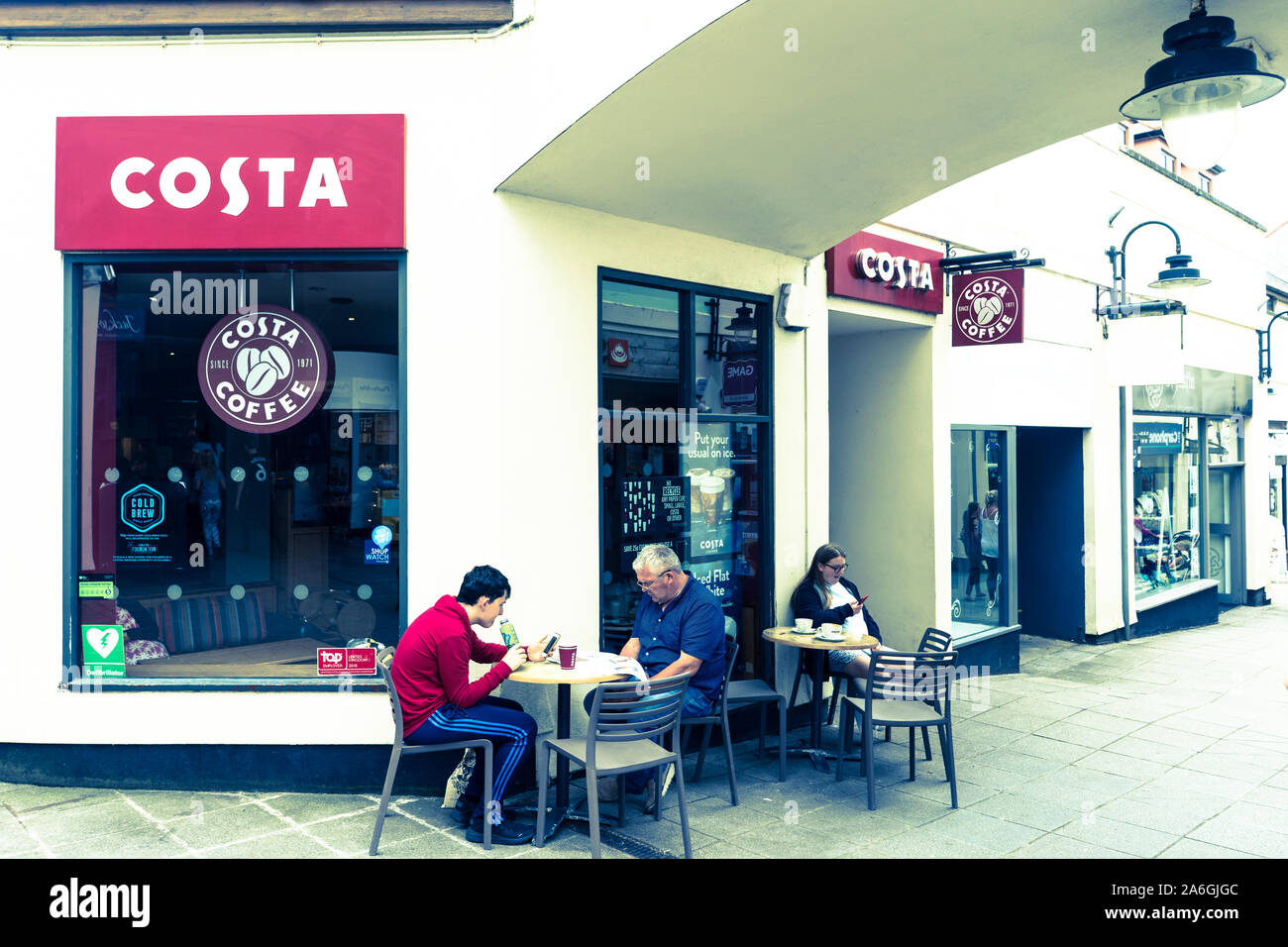 People enjoying coffee and food outside the Costa coffee shop in the ...