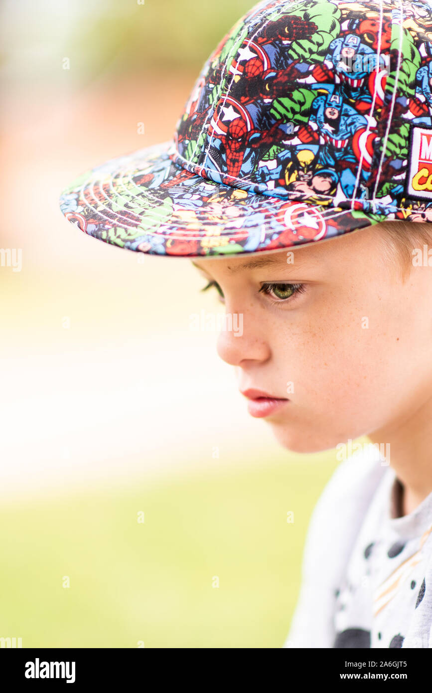 A handsome boy with ADHD, Autism, Asperger Syndrome sitting at the park ...