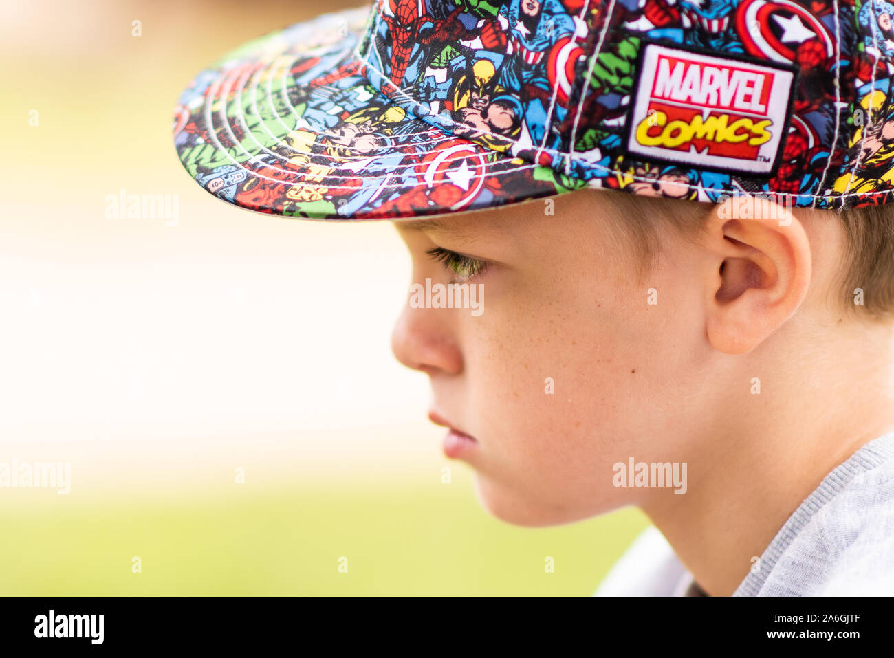 A handsome boy with ADHD, Autism, Asperger Syndrome sitting at the park ...