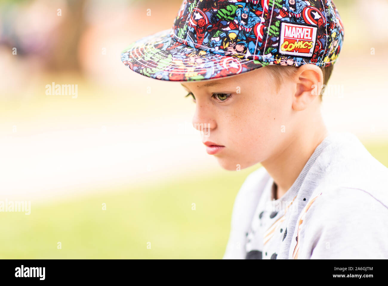 A handsome boy with ADHD, Autism, Asperger Syndrome sitting at the park ...