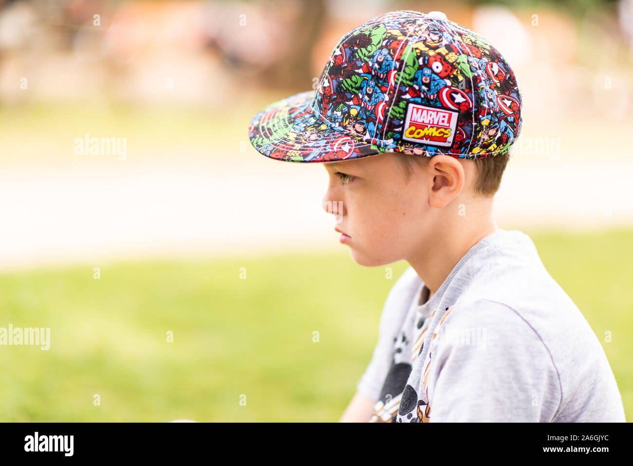 A handsome boy with ADHD, Autism, Asperger Syndrome sitting at the park ...