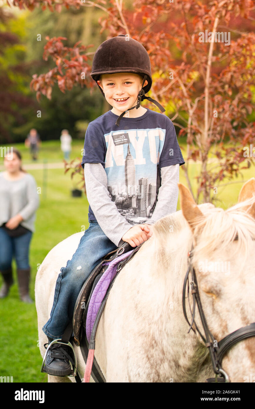 A little boy with Autism, ADHD, Aspergers Syndrome, riding a horse with ...