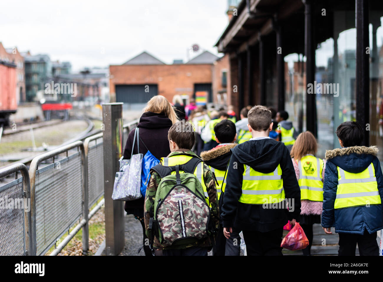 A group of school children walking in the street on a school trip ...