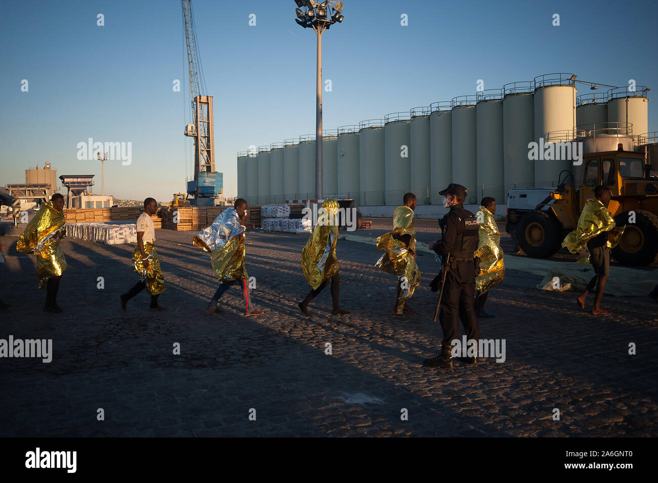 Sub Saharan migrants in a queue walking towards a humanitarian ...