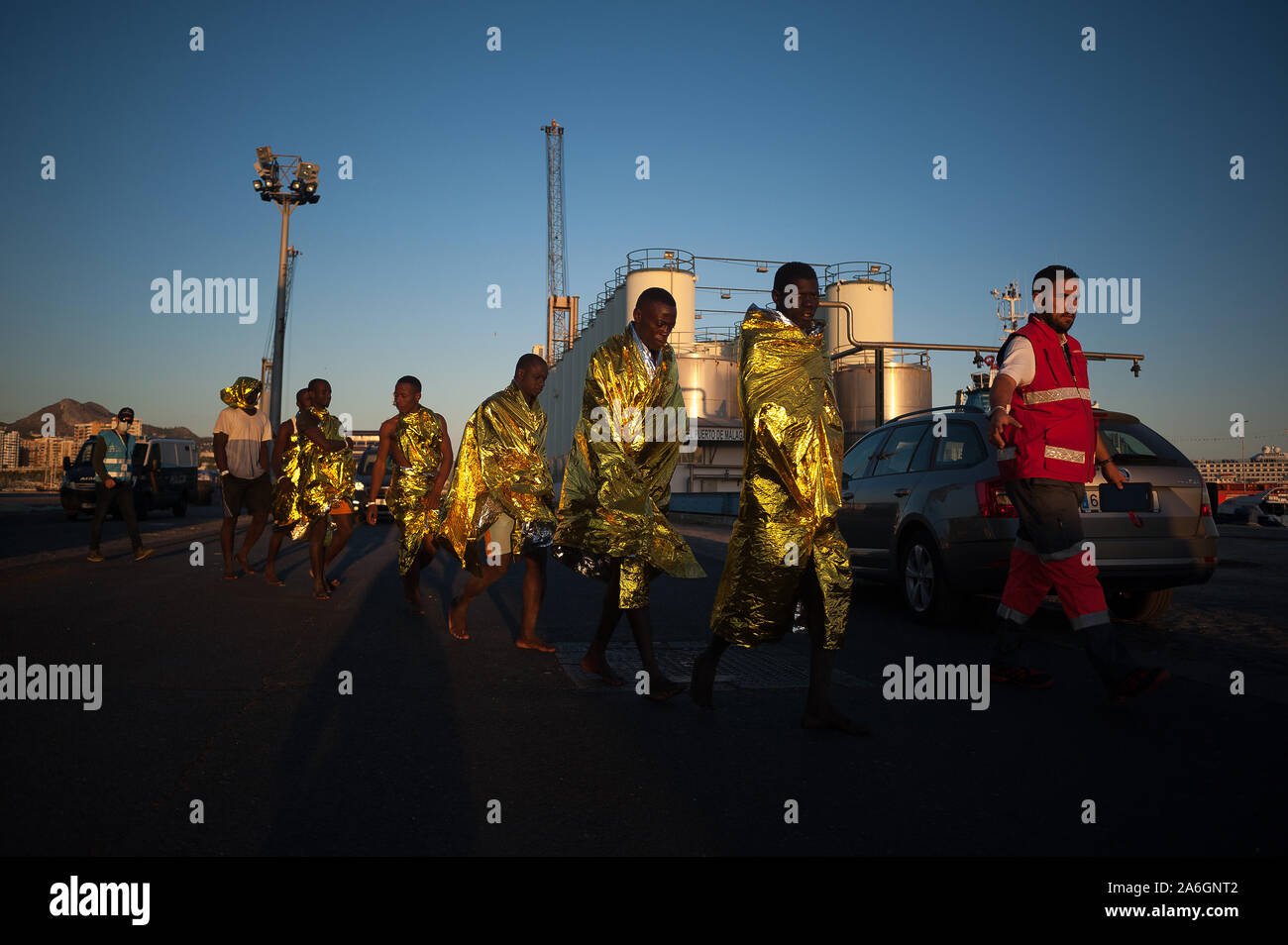 Sub Saharan migrants in a queue walking towards a humanitarian ...