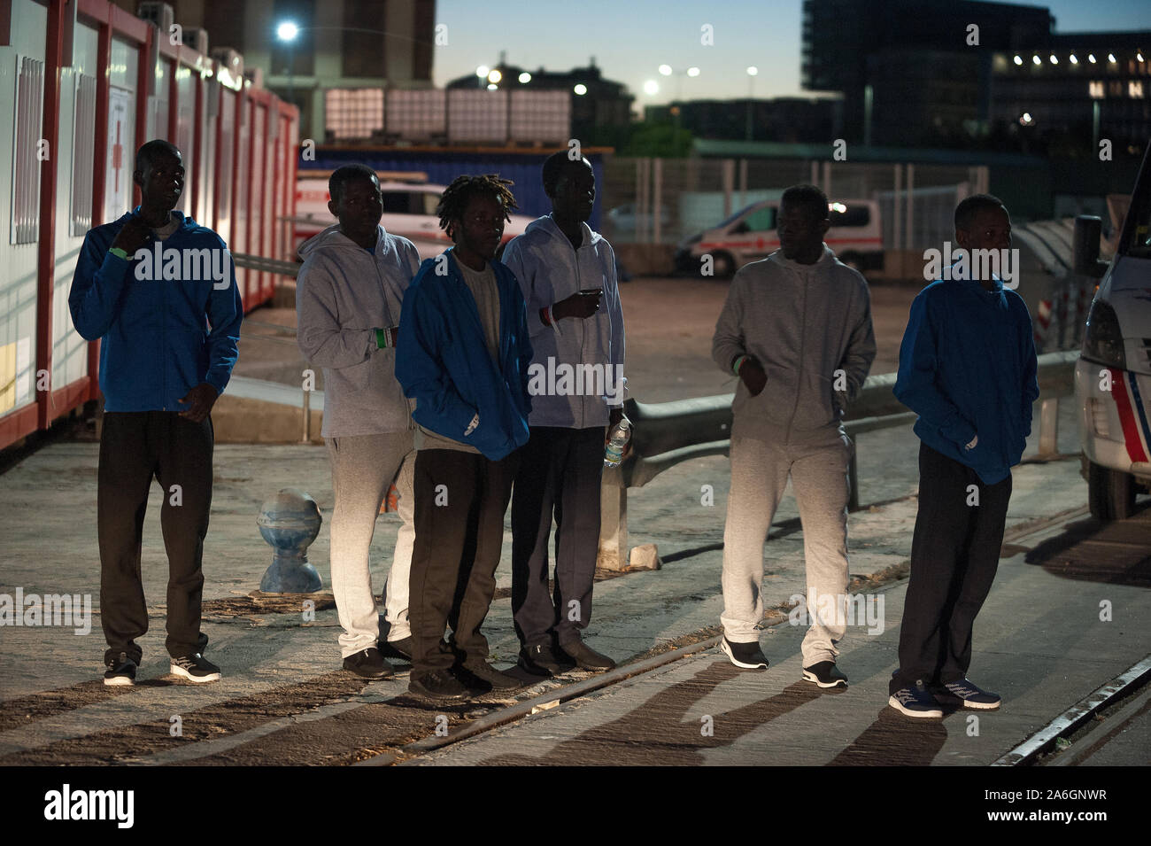 Sub Saharan migrants waiting outside the humanitarian emergency stall ...