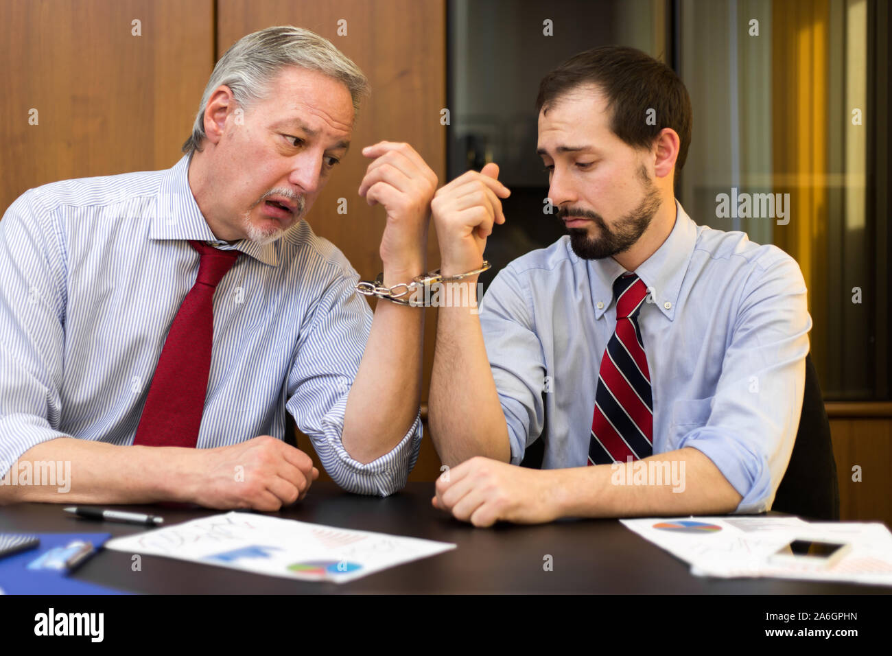 Two businessmen forced to work together bonded by handcuffs Stock Photo ...
