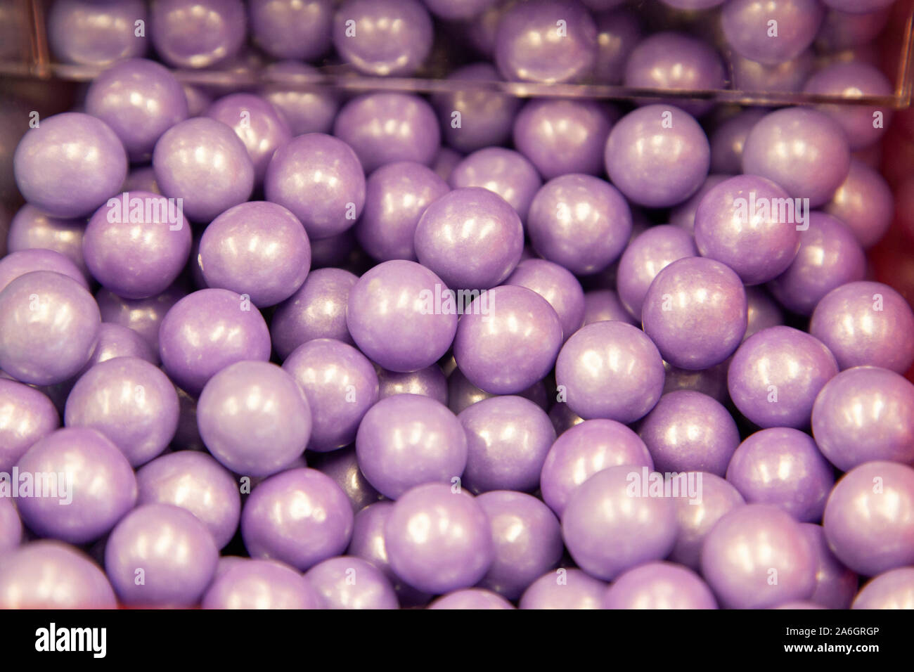 round hard shelled mauve or purple coloured candy Stock Photo - Alamy