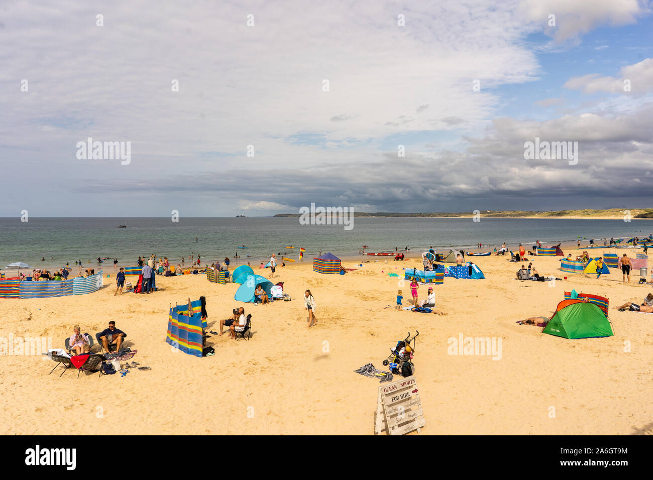 Beach goers sunbath, surf, kayak and enjoy family time at one of the ...