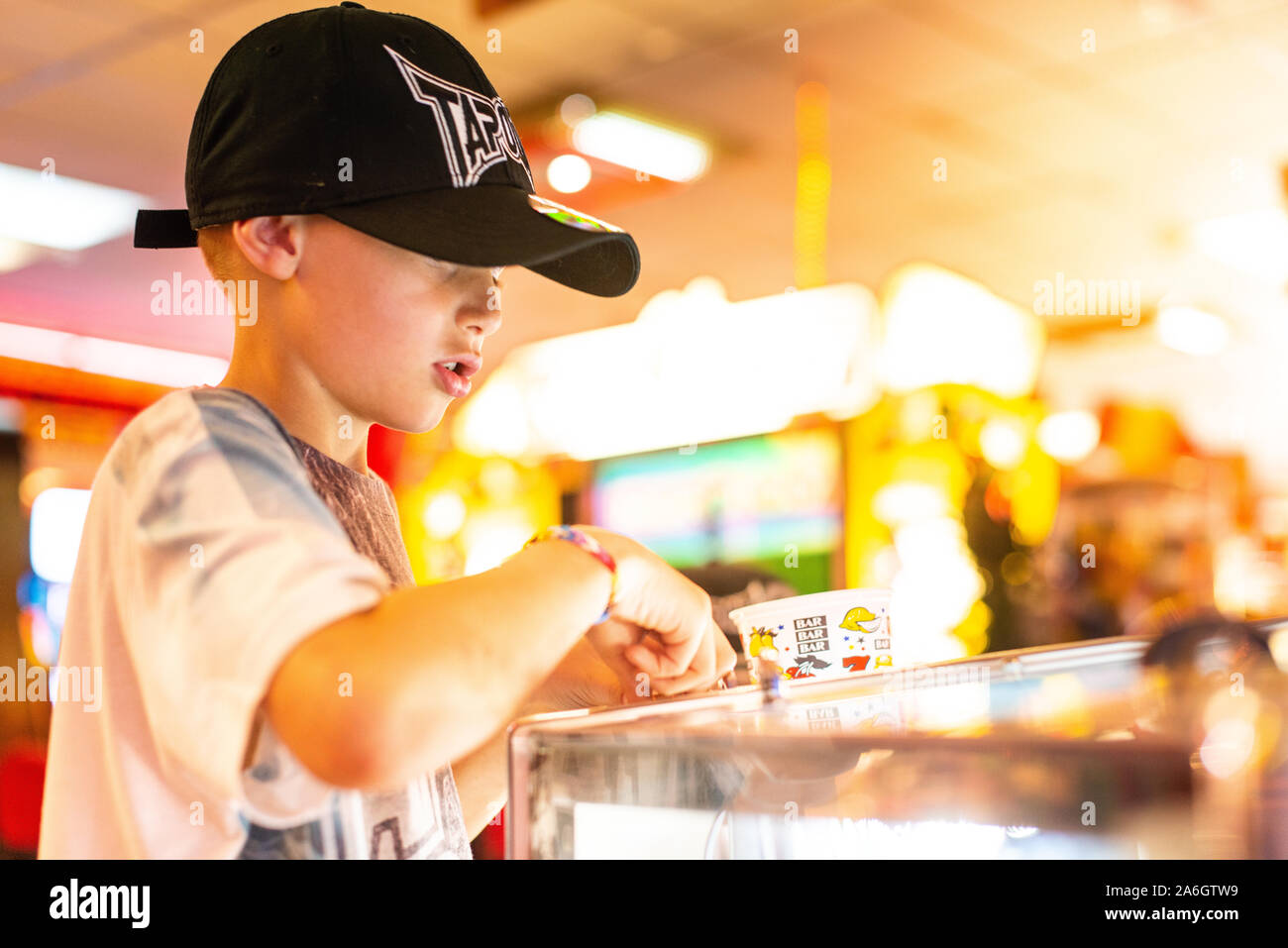 A child playing the arcade machines and posing for pictures Stock Photo ...