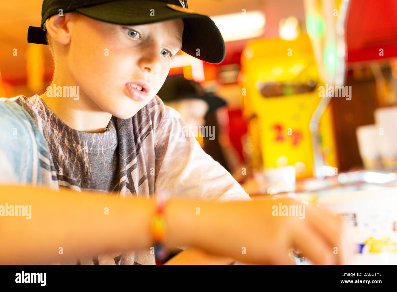 A child playing the arcade machines and posing for pictures Stock Photo ...