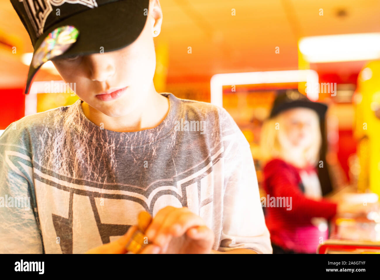 A child playing the arcade machines and posing for pictures Stock Photo ...
