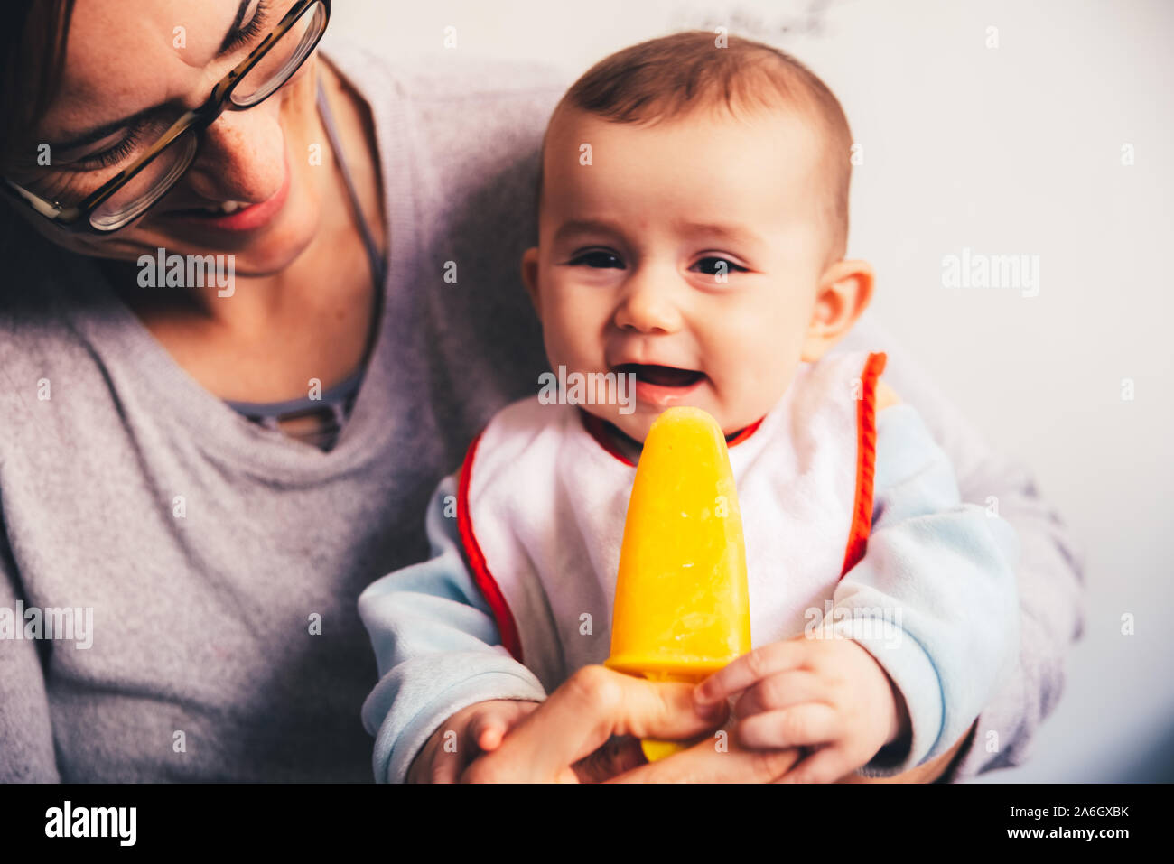 Baby smiling and drooling when trying for the first time an ice cream ...