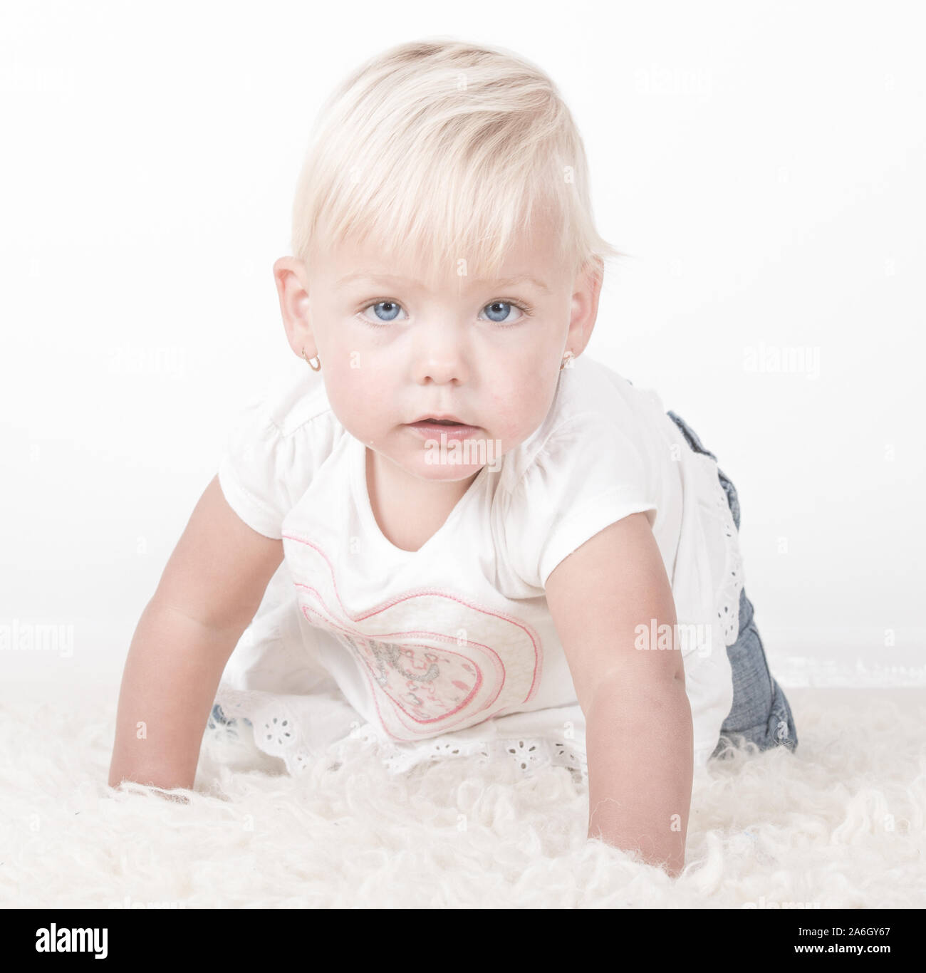 A cute, pretty little baby, toddler has some pictures taken by a ...