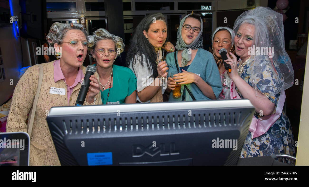 Men and women in fancy dress having fun and partying the night away ...