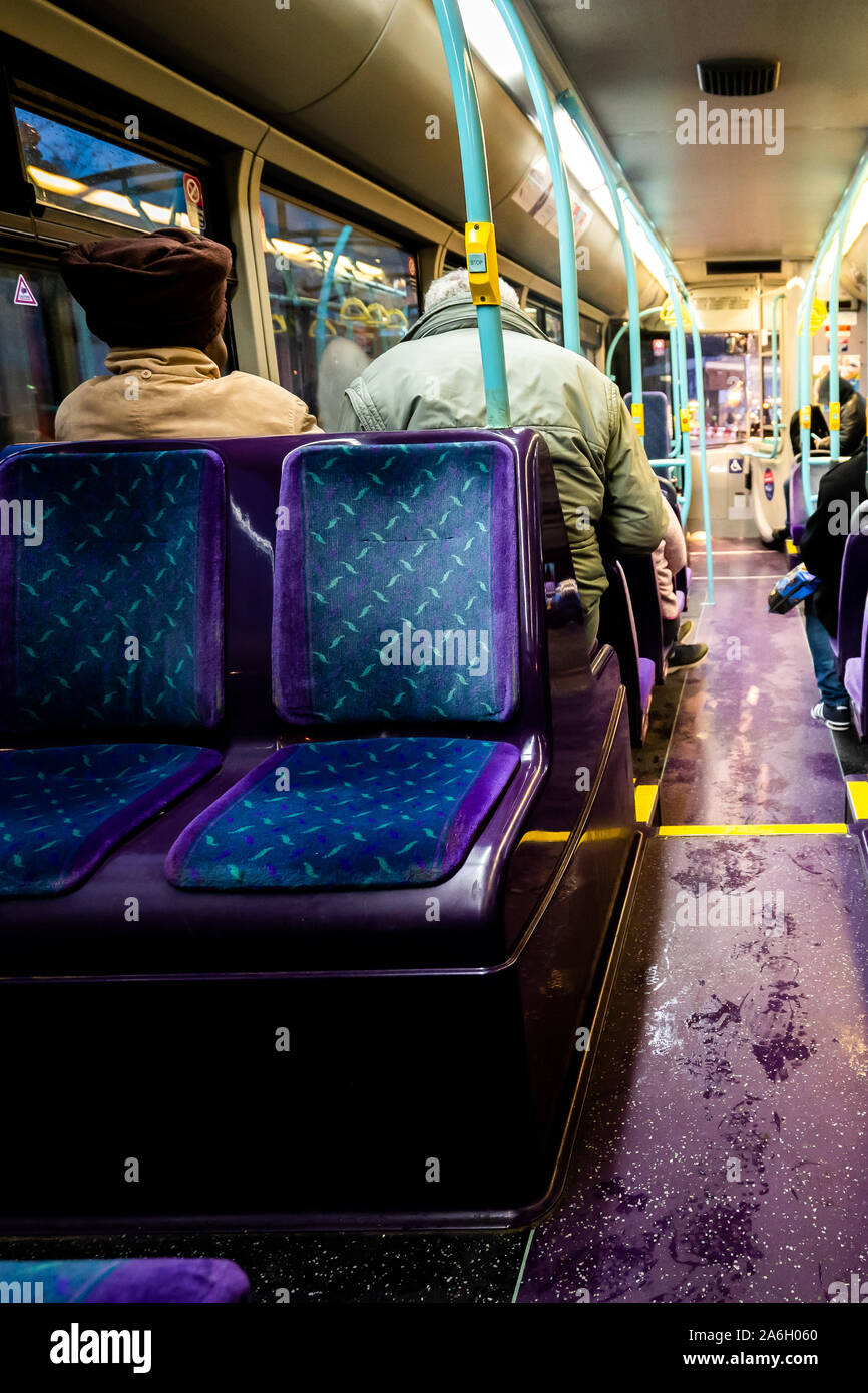 People seated on a bus at night time taking a journey from Longton to ...