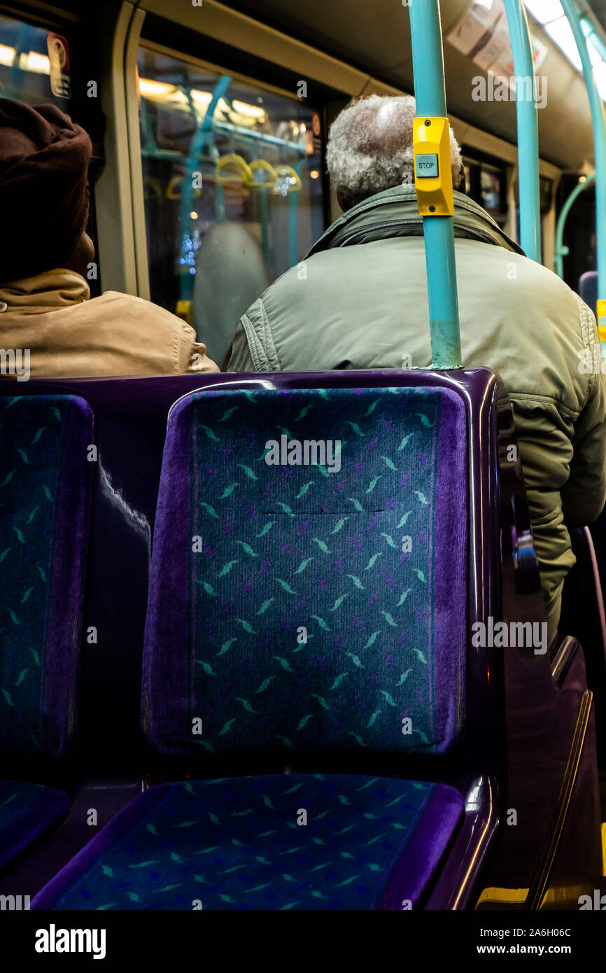 People seated on a bus at night time taking a journey from Longton to ...
