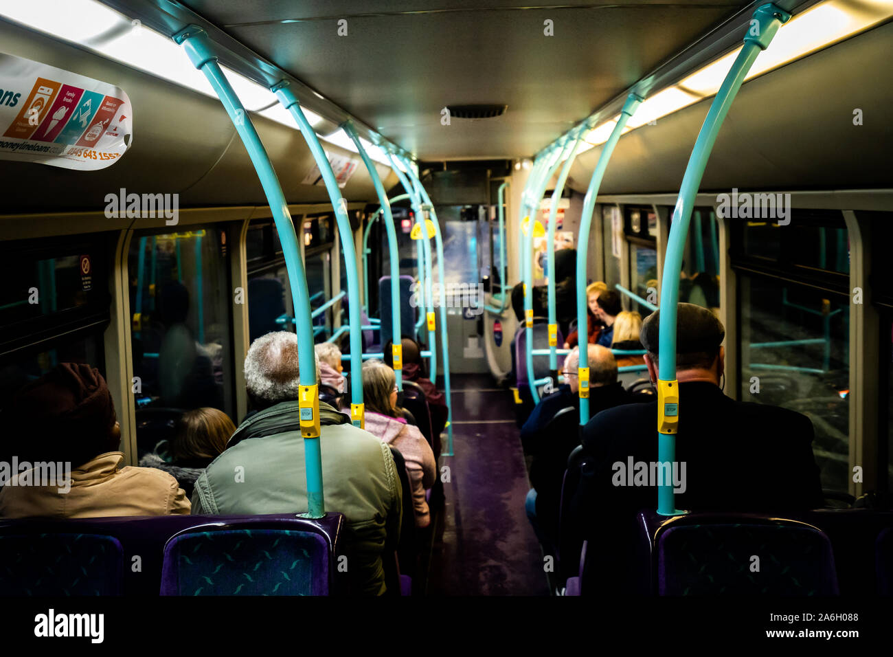 People seated on a bus at night time taking a journey from Longton to ...