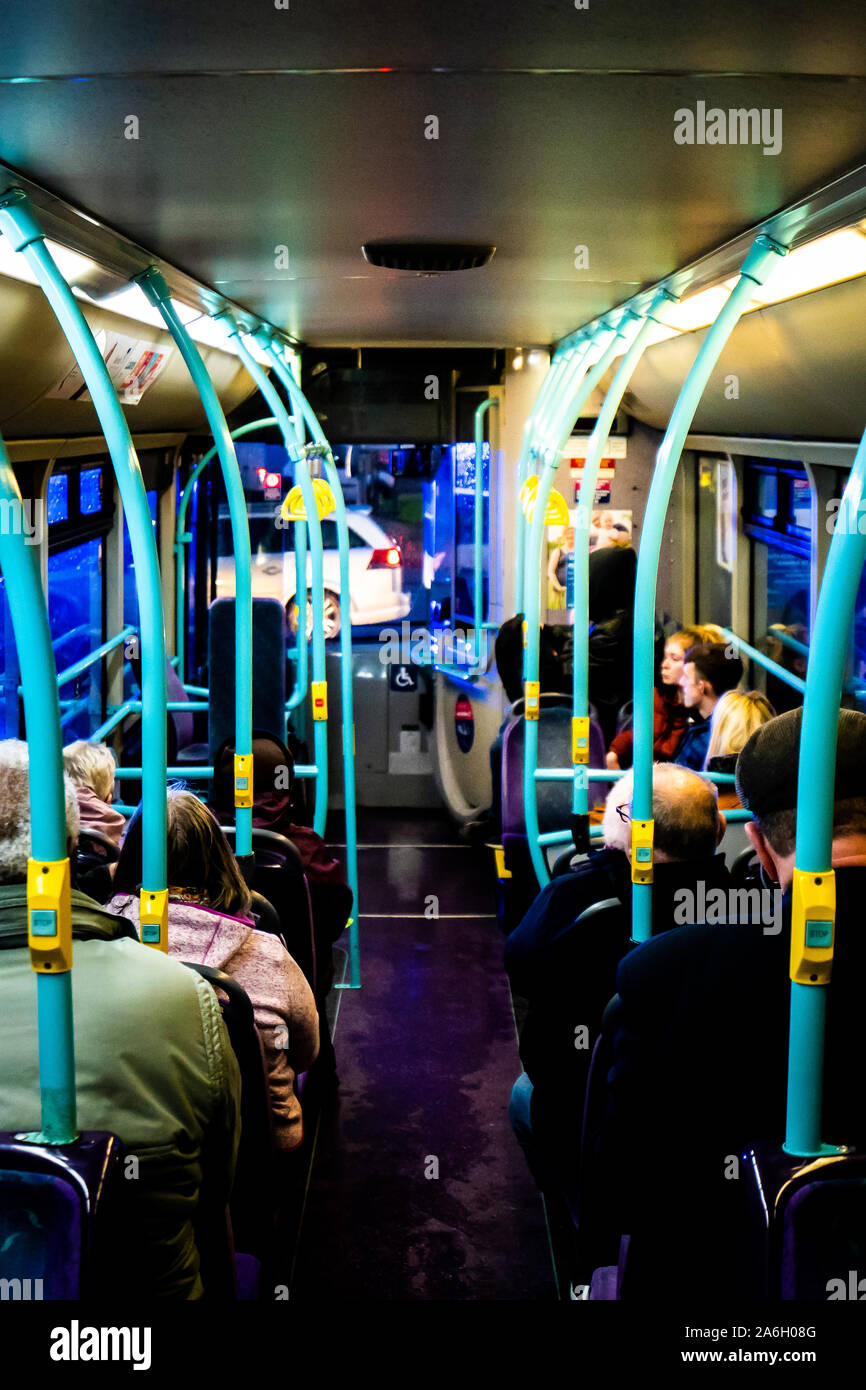 People seated on a bus at night time taking a journey from Longton to ...