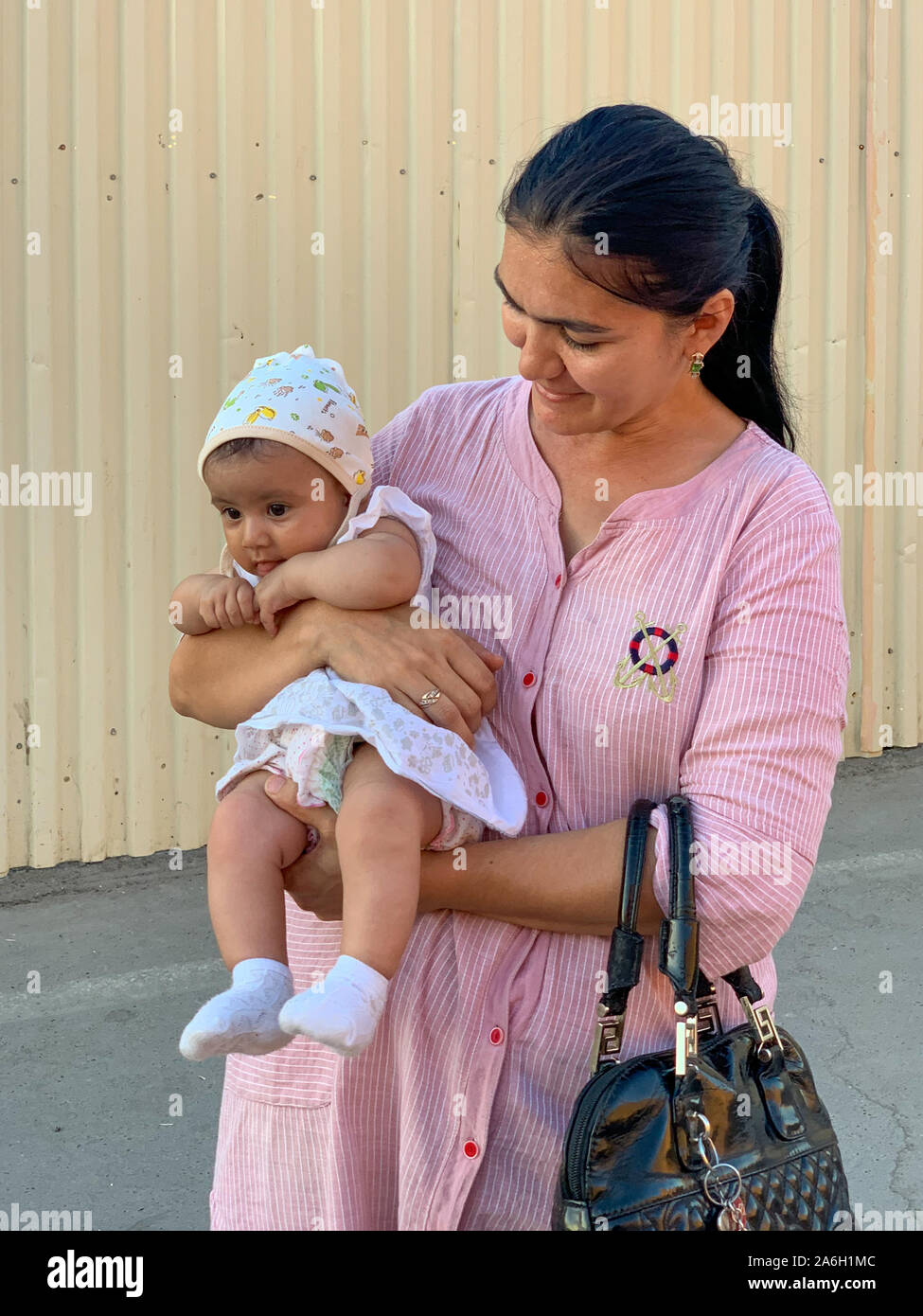 Bukhara, Uzbekistan - July 12, 2019: Uzbekistani mother and her child ...