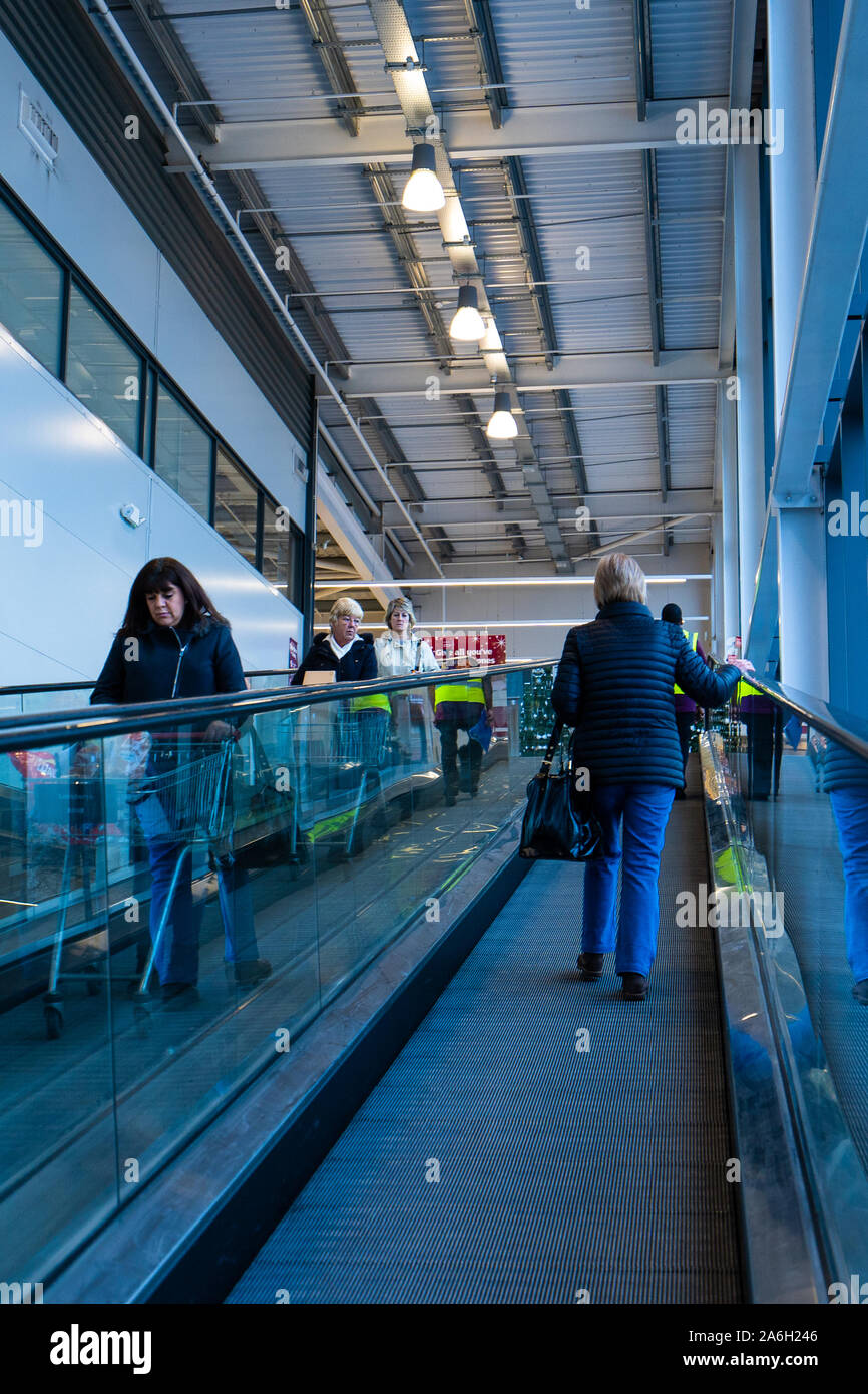 People ride the escalator at the large Sainsbury's store, shop ...