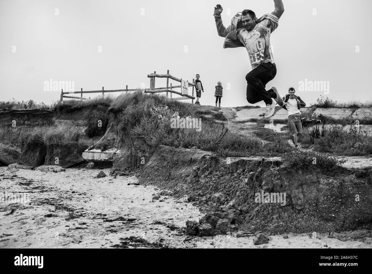 Man jumping off the cliff Black and White Stock Photos & Images - Alamy